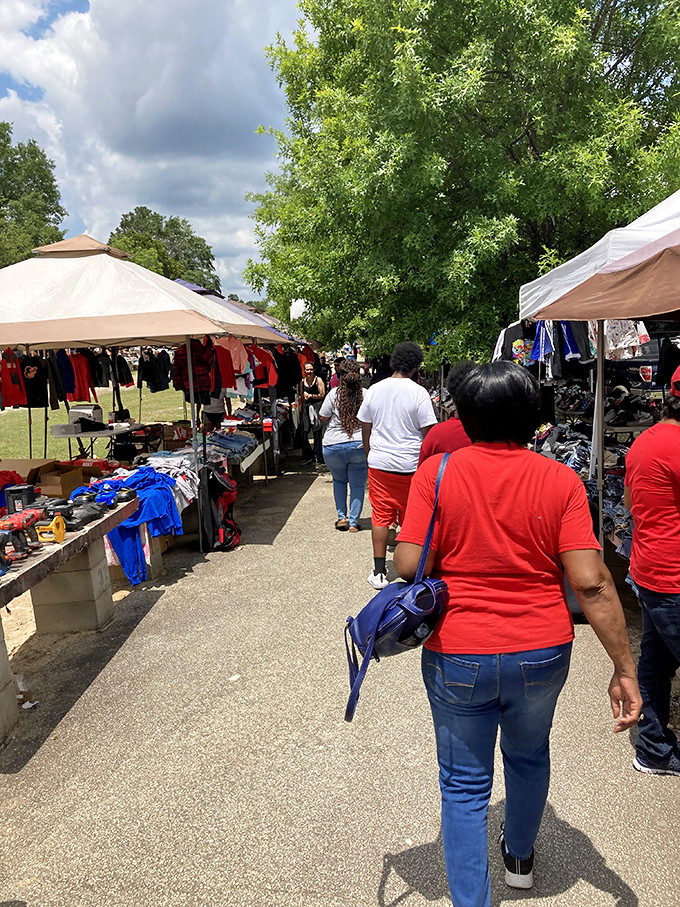 The outdoor market experience in full swing. Under Georgia's blue skies, vendors and shoppers create the timeless dance of commerce.
