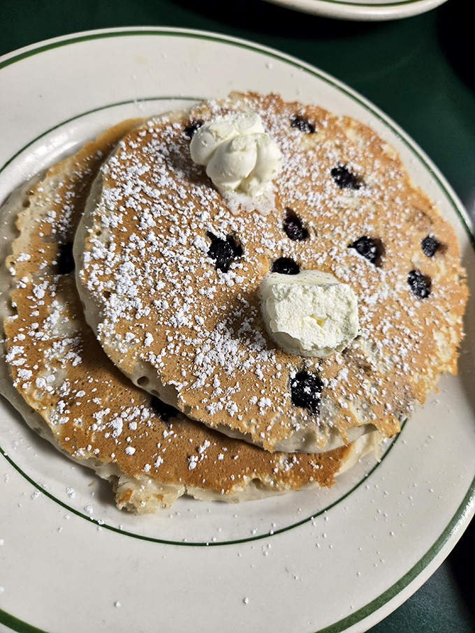 Blueberry pancakes with butter islands slowly melting into sweet oblivion. The powdered sugar is just showing off at this point.