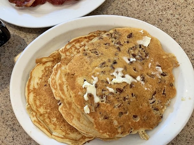 Pancakes that wear their pecans like badges of honor, stacked high and waiting for that ceremonial maple syrup baptism.