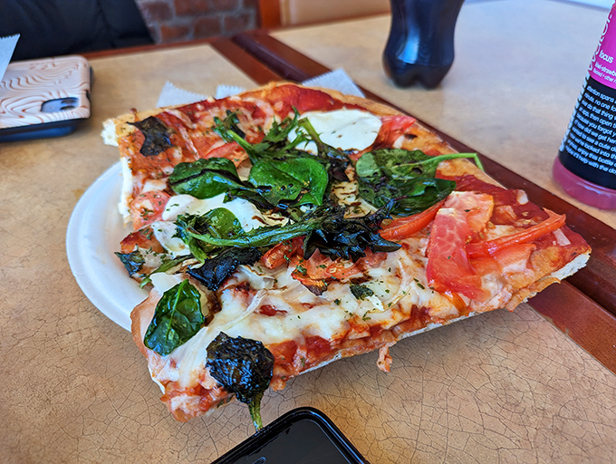 This isn't just pizza—it's a rectangular masterpiece of crisp crust, tangy sauce, and fresh toppings that makes chain delivery seem like a sad compromise.