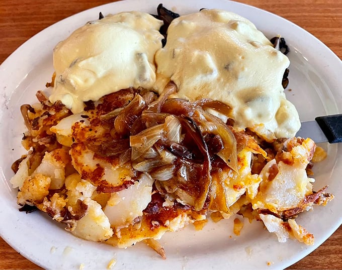 Potato paradise topped with poached eggs and hollandaise. Those caramelized onions aren't just ingredients—they're flavor ambassadors.