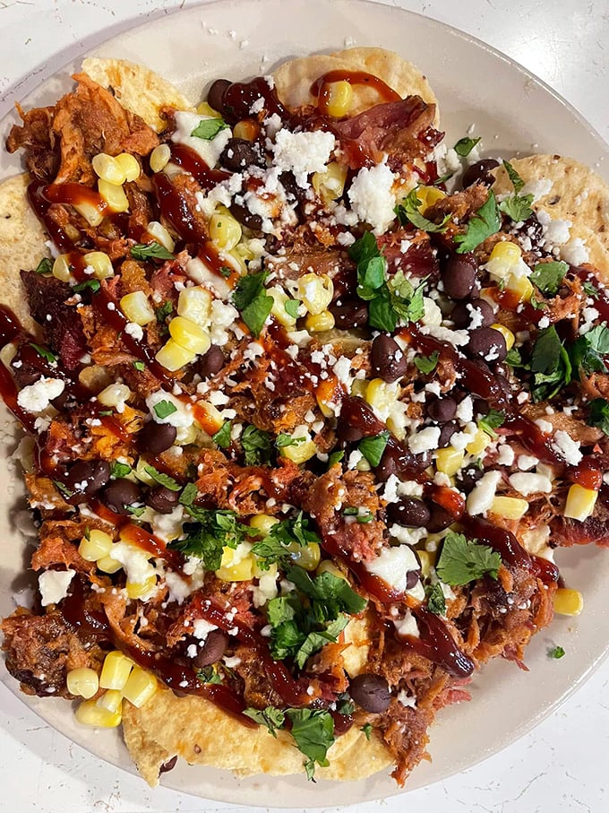 Pulled pork nachos that blur the line between appetizer and main event – a glorious mess of textures and flavors worth every napkin.