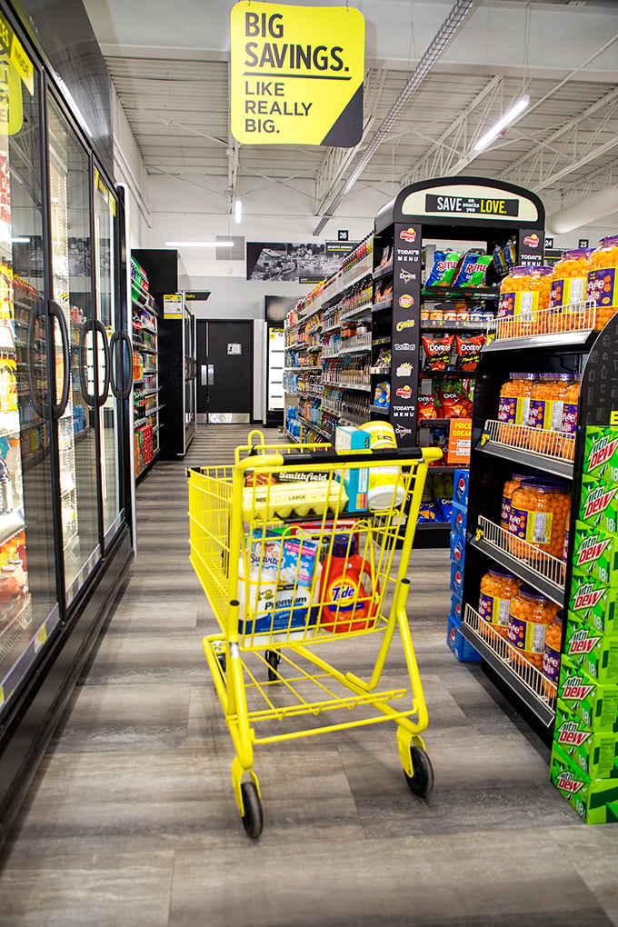 The yellow shopping cart in its natural habitat – already containing evidence that "just picking up one thing" is always a fantasy.
