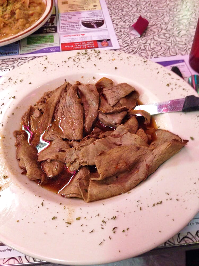 Tender slices of roast beef lounging in their natural juices—a carnivore's lullaby that whispers "nap time" with every savory bite.