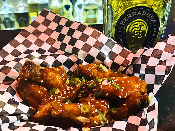 These wings aren't just tossed in sauce—they're lacquered in sticky-sweet goodness, sprinkled with sesame seeds, and begging to be devoured alongside an ice-cold beer.