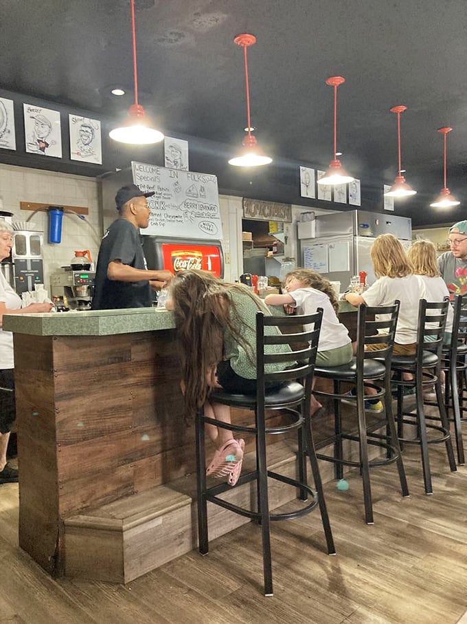Where the magic happens—staff working behind the counter with the focused precision of people who take your breakfast satisfaction very seriously.