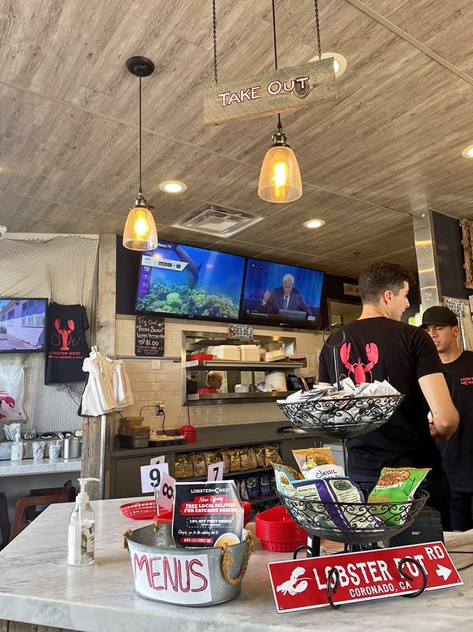 Where the magic happens—staff in their element preparing ocean-fresh delights. That hanging "Take Out" sign might be the most important directional guidance in Coronado.