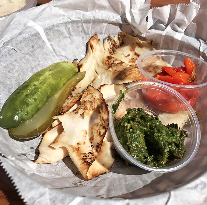 A turkey sandwich with sides that aren't afterthoughts. That pickle and those dips are the supporting actors who steal the scene.