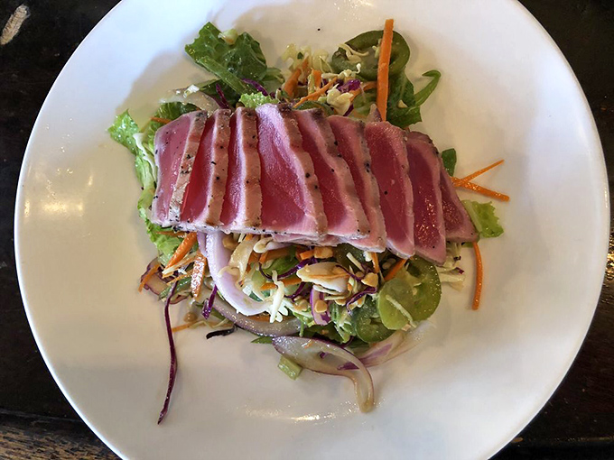 Perfectly seared ahi tuna, ruby-red center gleaming like jewels atop a vibrant salad—proof that healthy eating needn't sacrifice an ounce of pleasure.