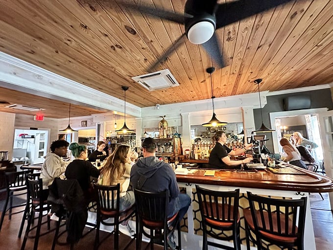The bar area buzzes with weekend energy – wooden ceilings, pendant lighting, and the unmistakable vibe of people who've made the right breakfast choice.