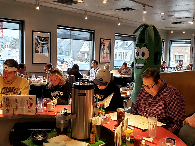 Where New York meets Nashville—a pickle mascot standing guard while diners fuel up on coffee and comfort food before facing the day.