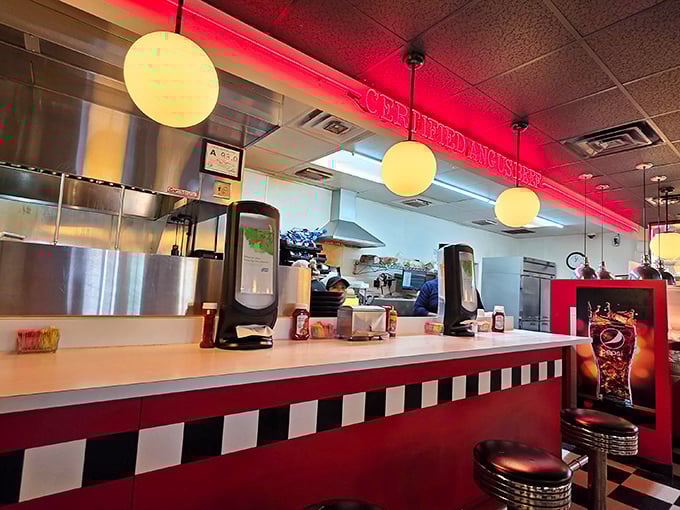 The counter seating puts you front row for the culinary show – red neon glow, checkered pattern, and stools that invite you to stay awhile.