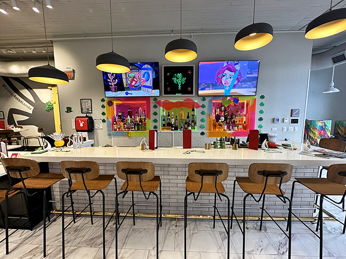 The bar area pops with colorful personality—where craft cocktails meet small-town charm under the warm glow of pendant lighting.