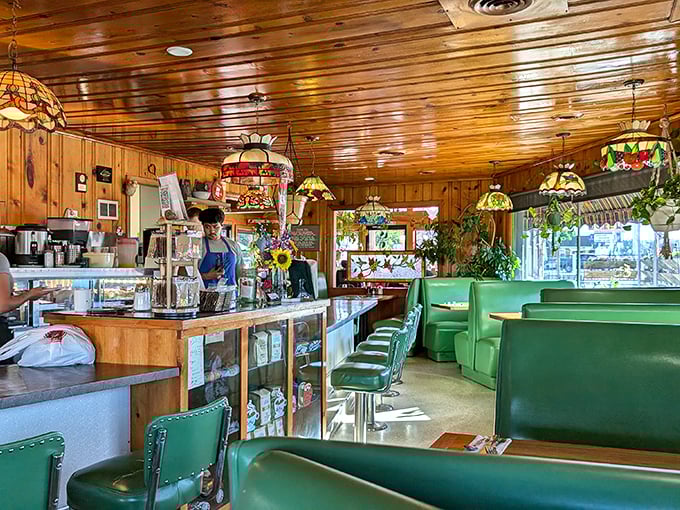 Stained glass lamps cast a warm glow over mint-green booths. This isn't just a restaurant—it's a time machine to when dining out was an occasion.