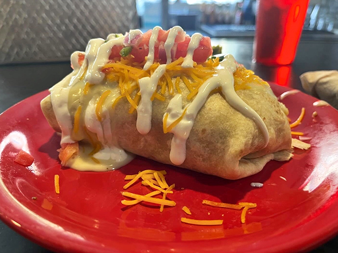 This isn't just a burrito—it's breakfast wrapped in a warm hug, then smothered with cheese and sauce. Morning comfort food that requires both hands and zero shame.