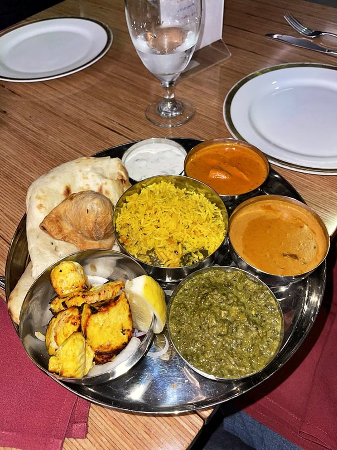 The thali—India's original sampler platter—where you can travel across regions without leaving your seat. Flavor geography at its finest.