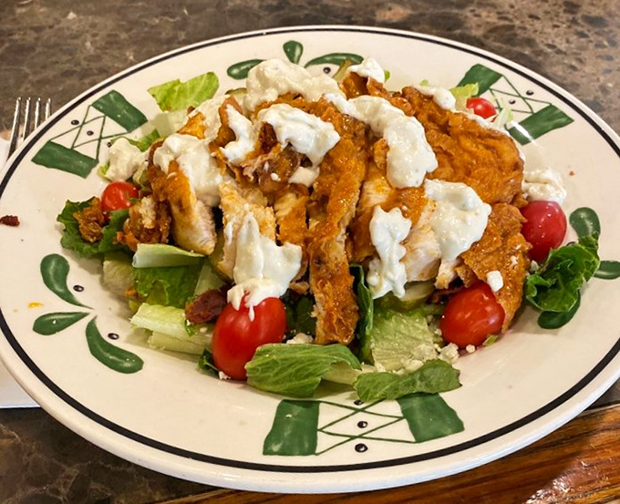 A salad that doesn't apologize for being healthy—crisp greens and juicy tomatoes playing backup to perfectly seasoned chicken.