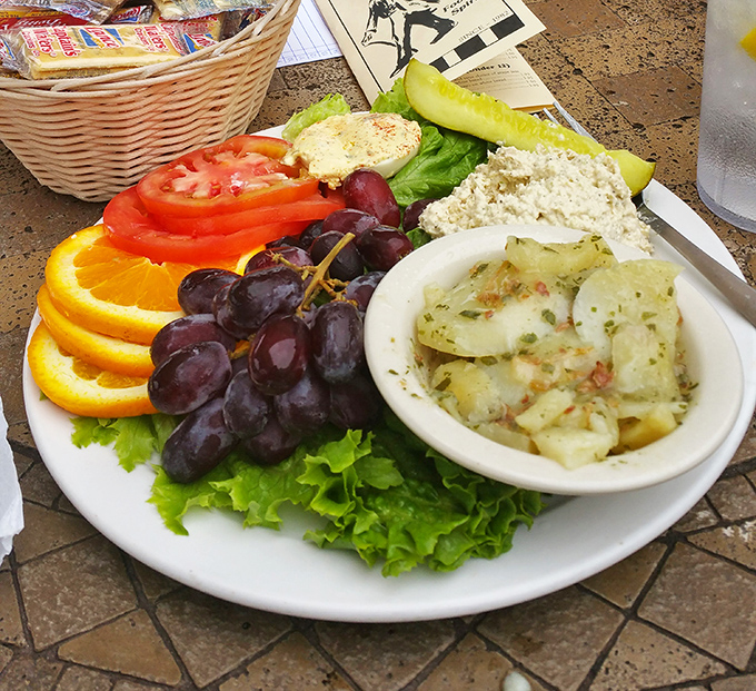 A plate that understands balance—protein, fruit, and carbs living in perfect harmony. This chicken salad plate might solve the mystery of world peace.