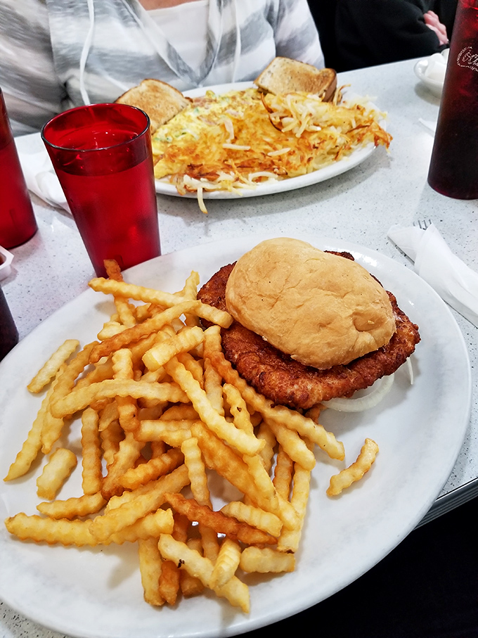 The breaded pork tenderloin sandwich – Iowa's unofficial state food – served with a mountain of crinkle fries that demands respect.