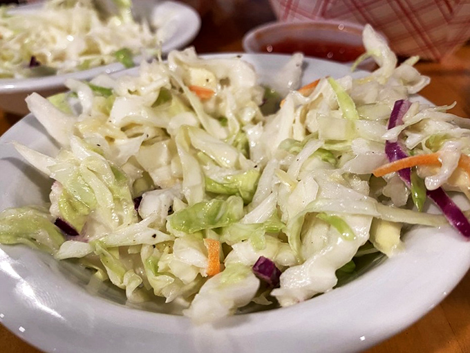 The coleslaw provides a crisp, refreshing counterpoint to all that glorious fried goodness – like a palate-cleansing intermission between acts.