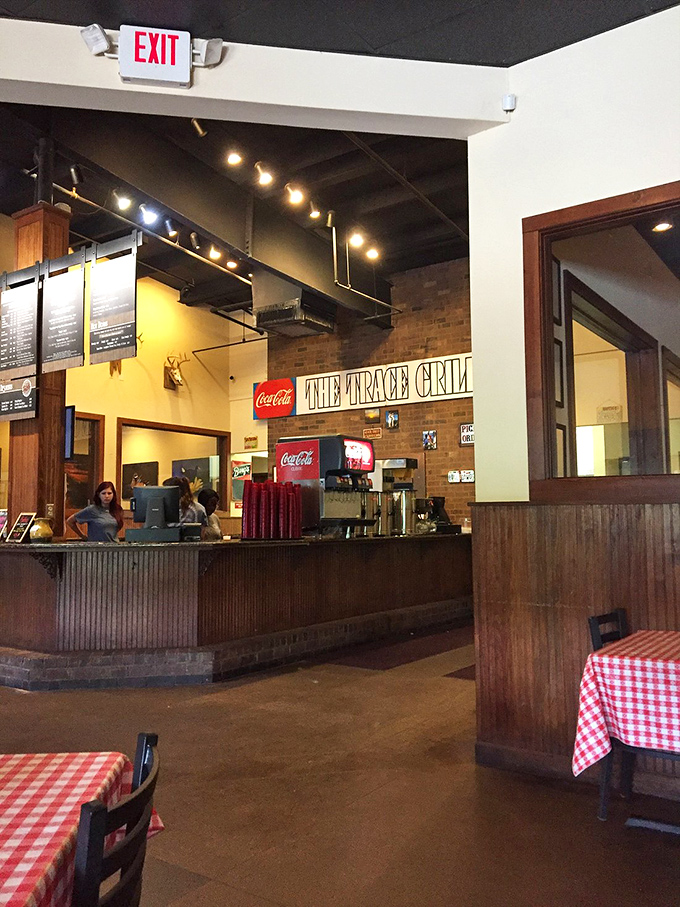 The counter where magic happens—where orders go in and plates of Southern comfort emerge. Notice the red-checkered tables standing ready for action.