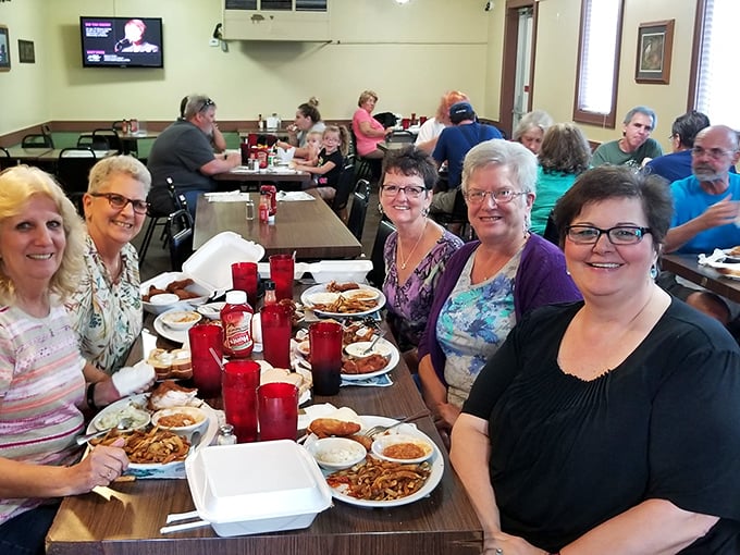Where strangers become friends over shared plates of legendary chicken—a community built one crispy bite at a time.