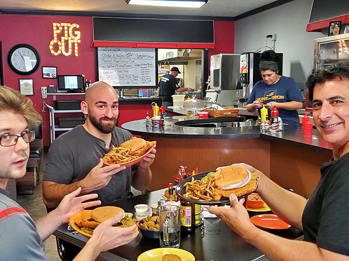 Where food meets fellowship—these lucky diners about to experience tenderloin nirvana while kitchen magic happens in the background.