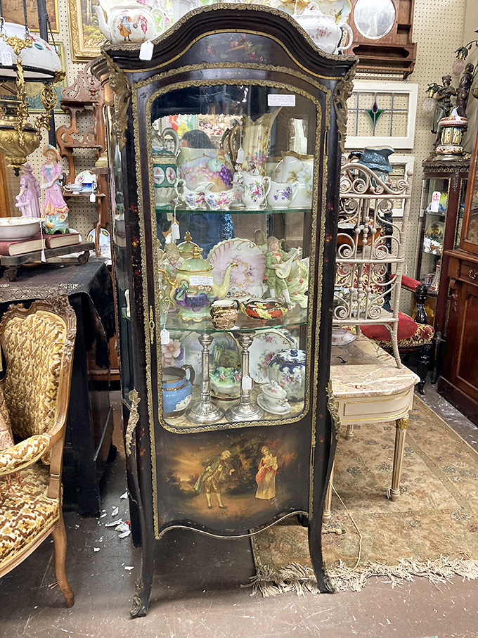 This curvaceous antique vitrine cabinet doesn't just display fine china—it elevates it to museum status. Victorian elegance with a French accent.
