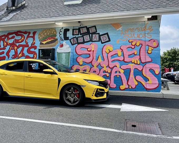 The colorful mural featuring burgers and shakes serves as a siren call to hungry drivers. Resistance is futile—and why would you even try?