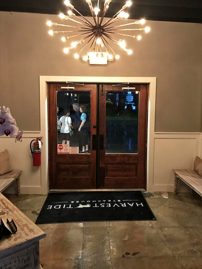 The entrance sets the tone with its starburst chandelier and wooden doors—like crossing the threshold into a world where everyday concerns take a back seat to culinary pleasure.