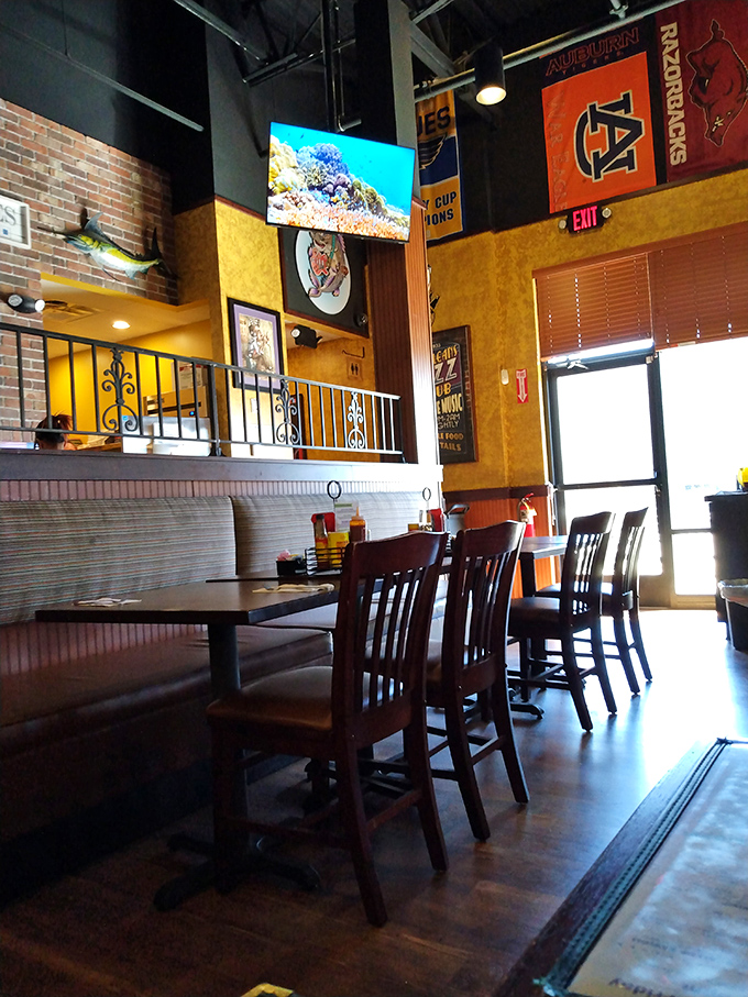 College pennants and seafood décor create that rare sweet spot between sports bar and fish shack that somehow feels exactly right.