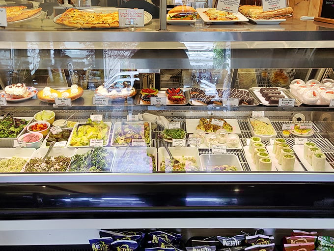 The display case—a museum of comfort where salads sit alongside chocolate-dipped delights, proving that balance in life is entirely optional.