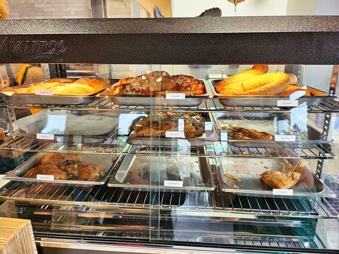 The pastry case—where willpower goes to die and "I'll just have a small piece" becomes the day's biggest fiction.