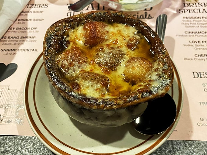 French onion soup that bubbles with promise under a golden cheese canopy. This isn't just soup—it's a warm hug in a crock on a chilly day.