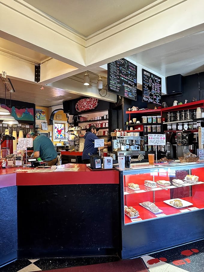 The beating heart of The Red Cup, where coffee dreams and pastry fantasies come true. The display case tempts you with sweet possibilities.