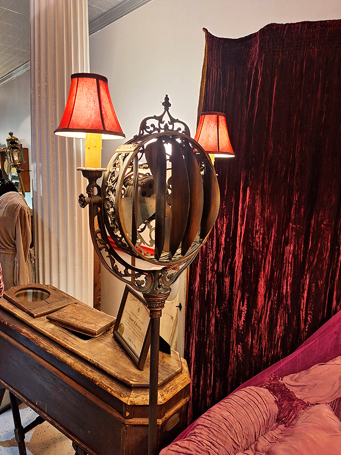 This ornate funeral lamp with its red shades cast a warm, flattering light—because even in the 19th century, good lighting was essential for life's final appearance.