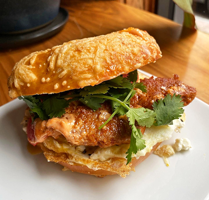 Sandwich architecture at its finest: layers of flavor stacked with artistic precision. That cilantro isn't just garnish—it's the exclamation point on a delicious sentence.