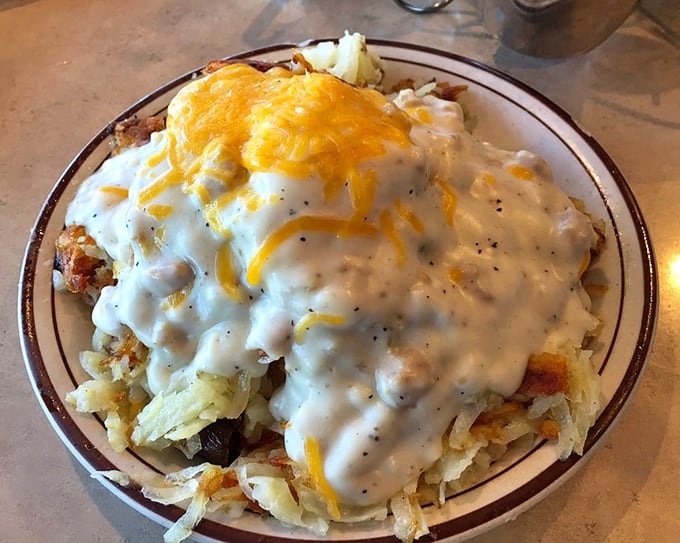 Behold: hash browns smothered in country gravy and cheese—comfort food that hugs your soul from the inside out.
