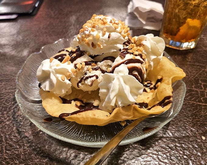 Dessert that defies gravity—whipped cream mountains with chocolate rivers flowing down crispy tortilla valleys. Spoon required, sharing optional.
