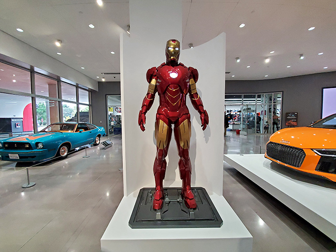 Even Iron Man needs wheels sometimes. Tony Stark's alter ego stands guard among the supercars—both equally engineered for performance.
