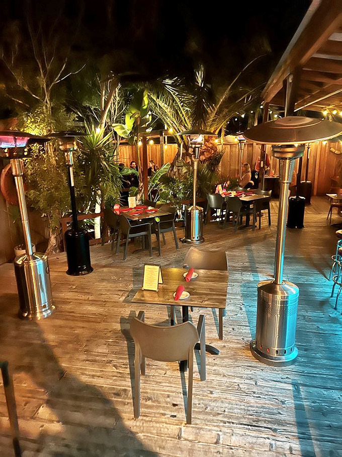 The outdoor patio feels like a secret tropical garden, with heat lamps ensuring your island escape continues even when the coastal fog rolls in.