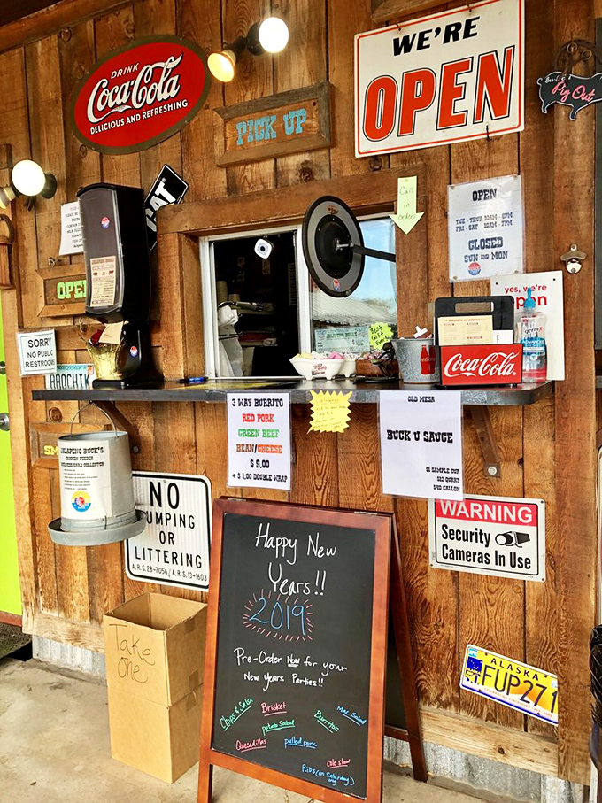 The pickup window—where dreams come true. Those handwritten specials tell you this place isn't working from some corporate recipe book.