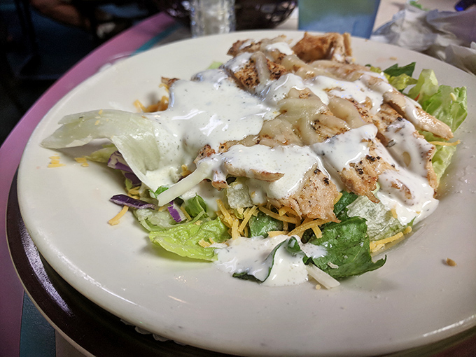 Fresh greens, grilled chicken, and house-made dressing – proof that salads don't have to be punishment between cheesecake adventures.