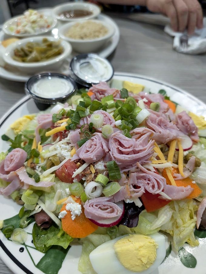 This isn't just a chef's salad—it's an architectural marvel of carefully arranged ham roses, cheese, and fresh vegetables that almost feels too pretty to eat.