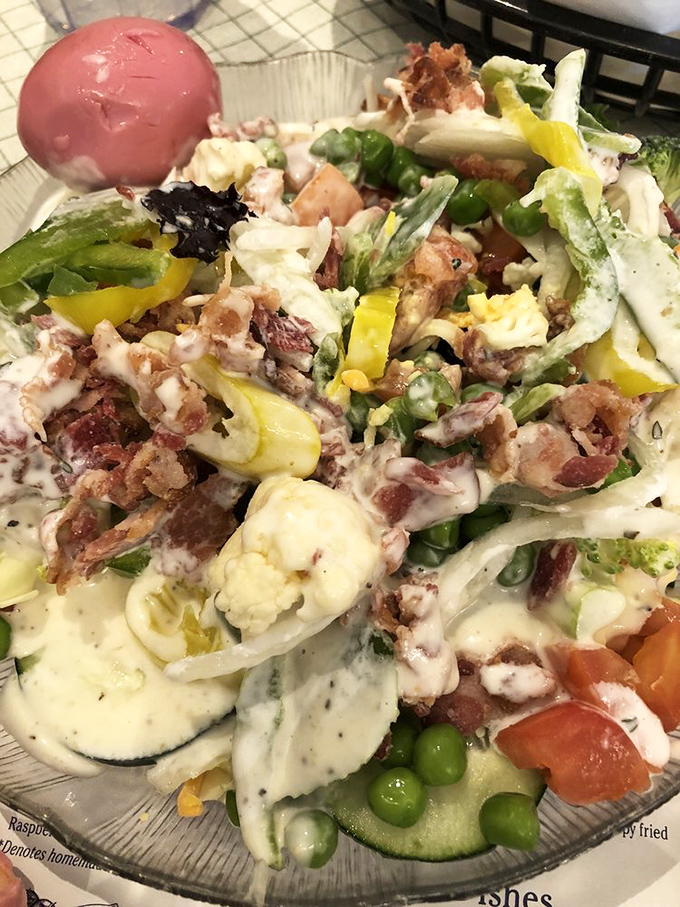 A salad that refuses to be an afterthought – loaded with fresh vegetables, eggs, and enough bacon to make you temporarily forget you're eating something healthy.