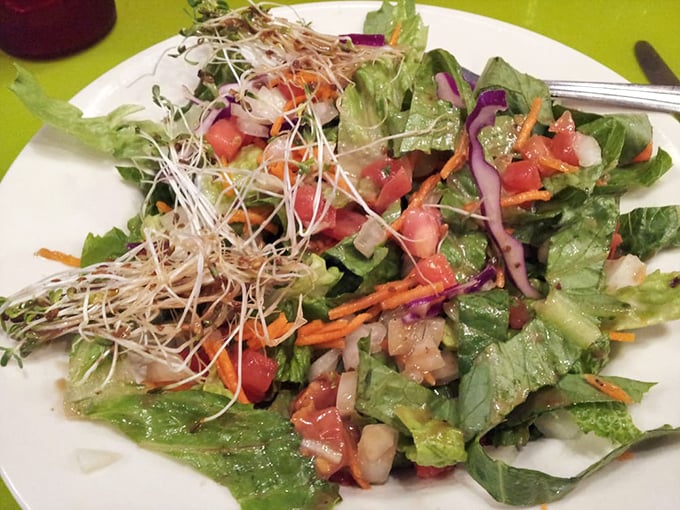 A salad that actually looks exciting—fresh greens topped with a confetti of vegetables and sprouts that might make you forget you're eating something healthy.