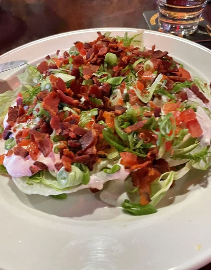 Not just a token salad—a legitimate contender. Crisp iceberg, bacon bits, and house-made dressing prove Slim's excels beyond the chili realm.