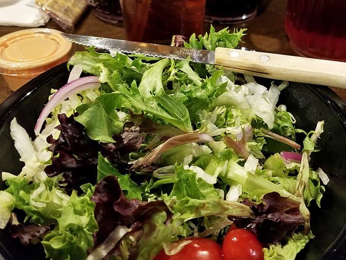 Even the salad looks like it's having more fun here—fresh, colorful, and completely judgment-free about what you ordered for your main course.