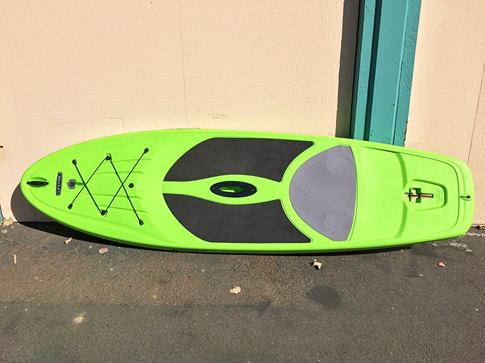 A bright green paddleboard promises aquatic adventures and the kind of fitness that doesn't feel like punishment.