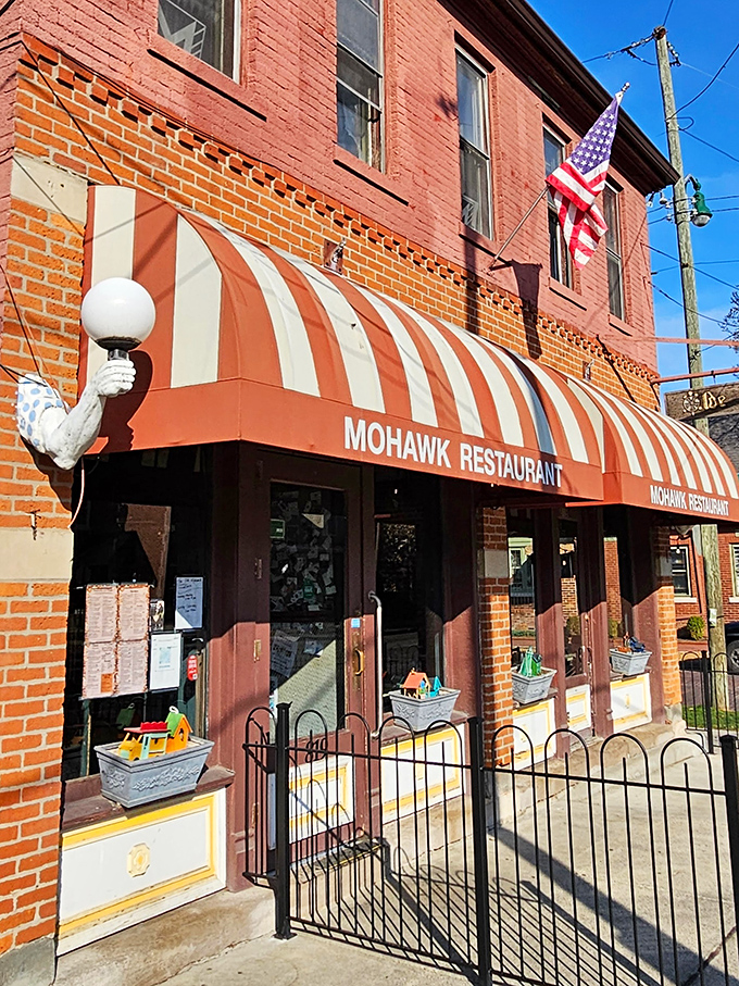 That striped awning and historic brick facade aren't just charming—they're a time machine to when restaurants focused on feeding your soul, not your Instagram.